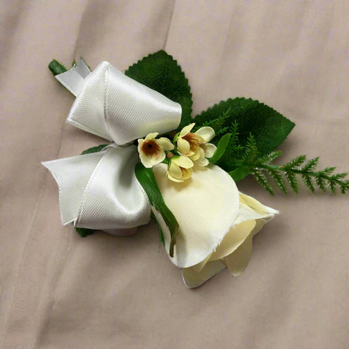 an artificial wedding buttonhole featuring a single lilac foam rose ...