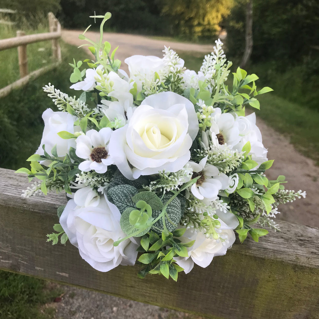 A brides wedding bouquet of artificial silk ivory roses and daisies ...