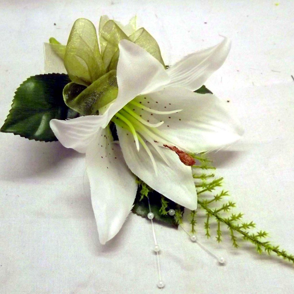 wedding buttonhole features an artificial ivory lily with silk foliage ...