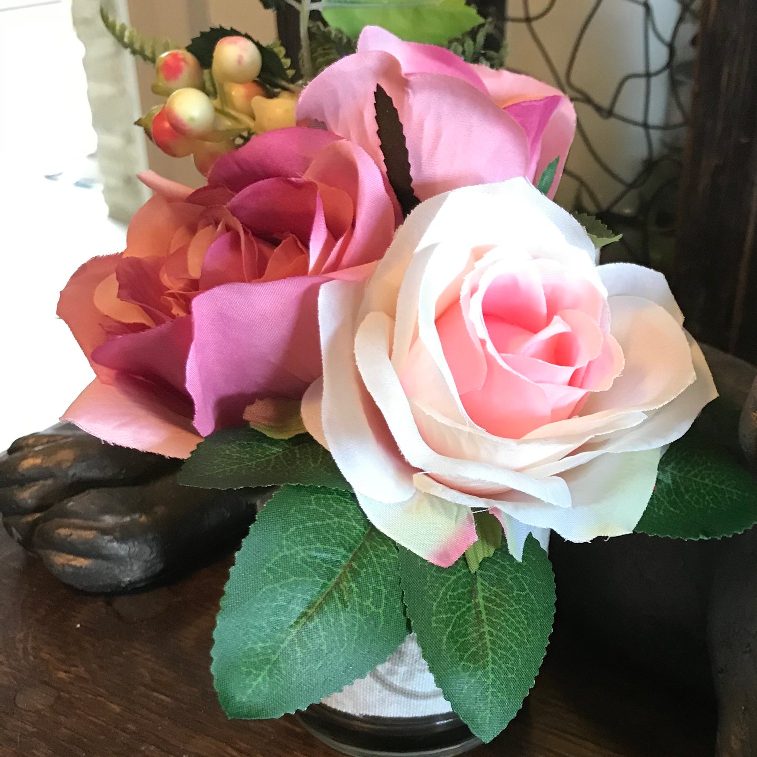 A small posy arrangement of pink silk roses in presention giftbag ...