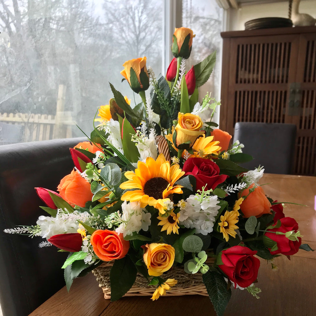A large bespoke front facing flower arrangement in rustic container ...