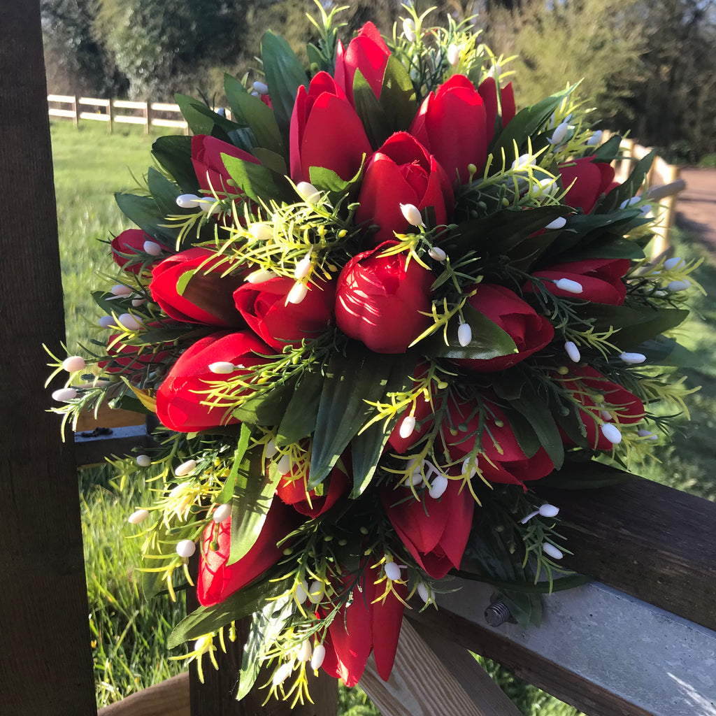 a wired cascade type bouquet featuring red silk tulips plus foliage ...